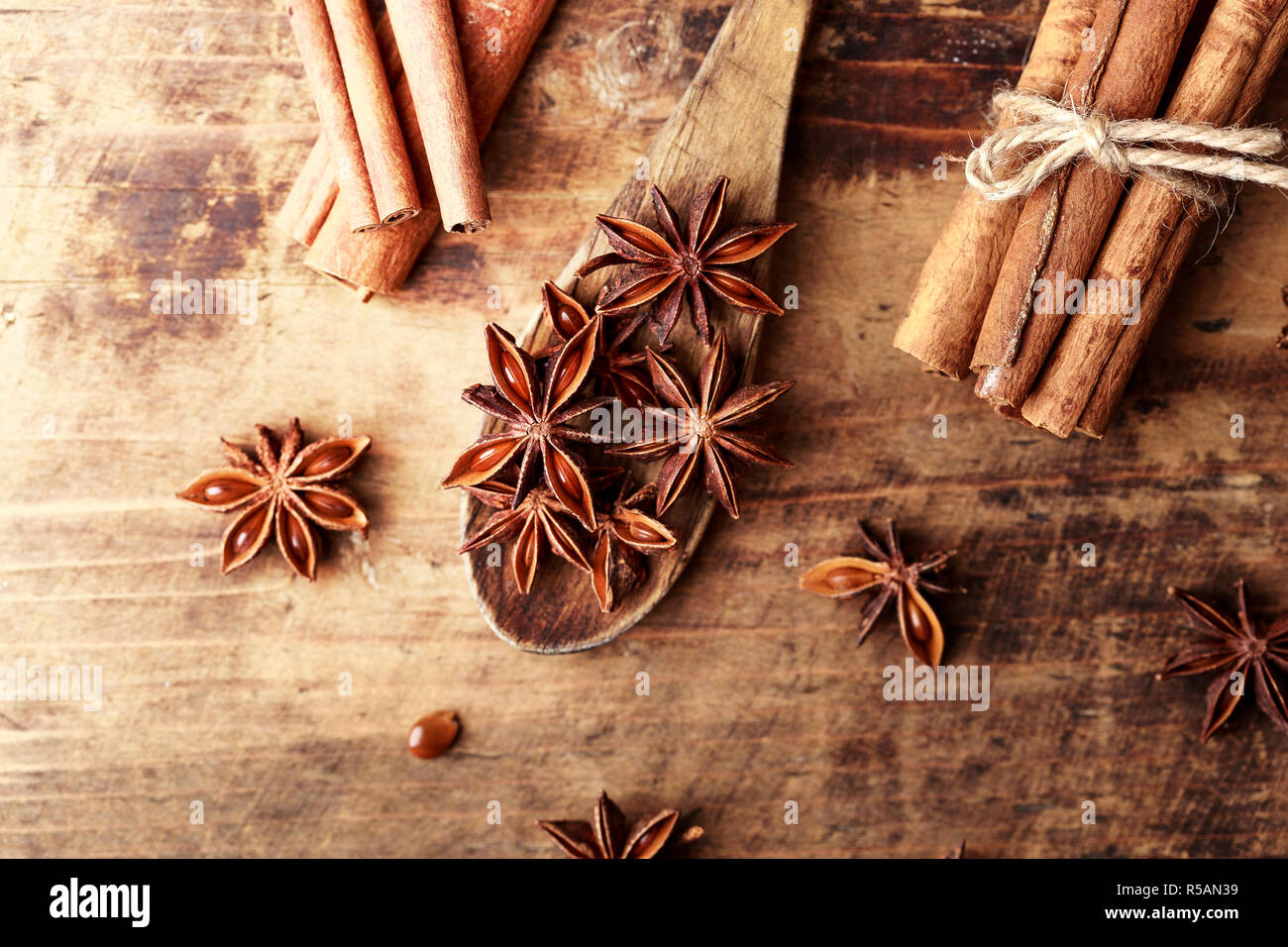 Anise star cinnamon sticks over wood background. Condiments on wooden ...