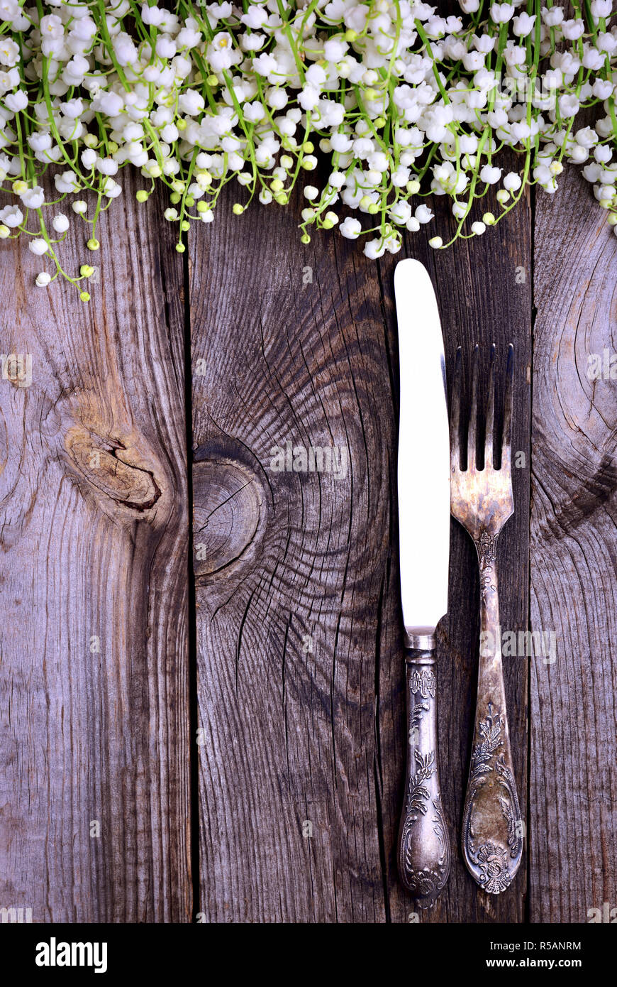 Iron fork and knife on a gray wooden background Stock Photo - Alamy