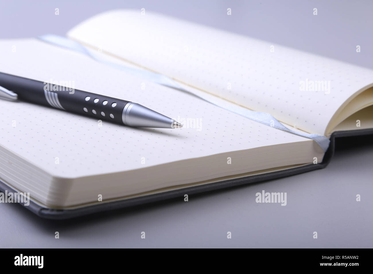 black stylish notebook and ballpoint pen on the office desk Stock Photo ...