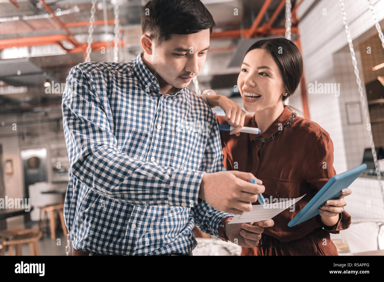Loving smiling woman hugging her man while working together Stock Photo ...
