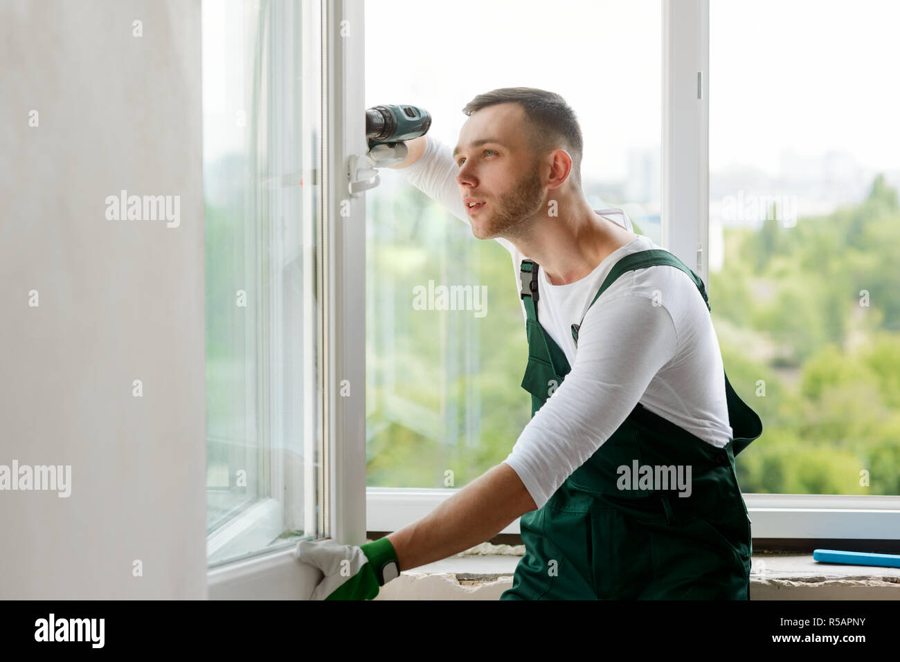 Man is mounting windows Stock Photo - Alamy