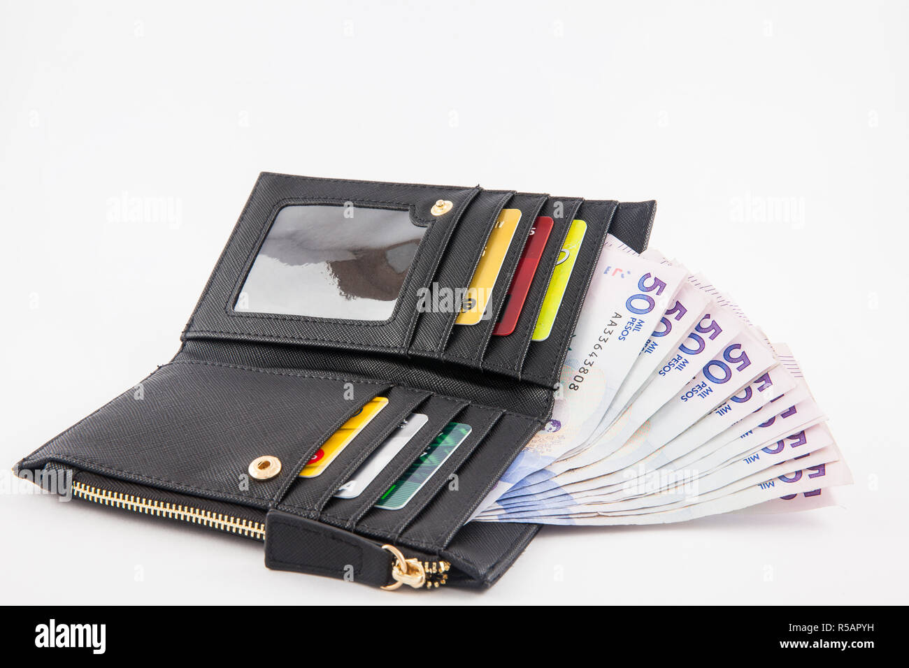 Black wallet filled with money and cards Stock Photo - Alamy
