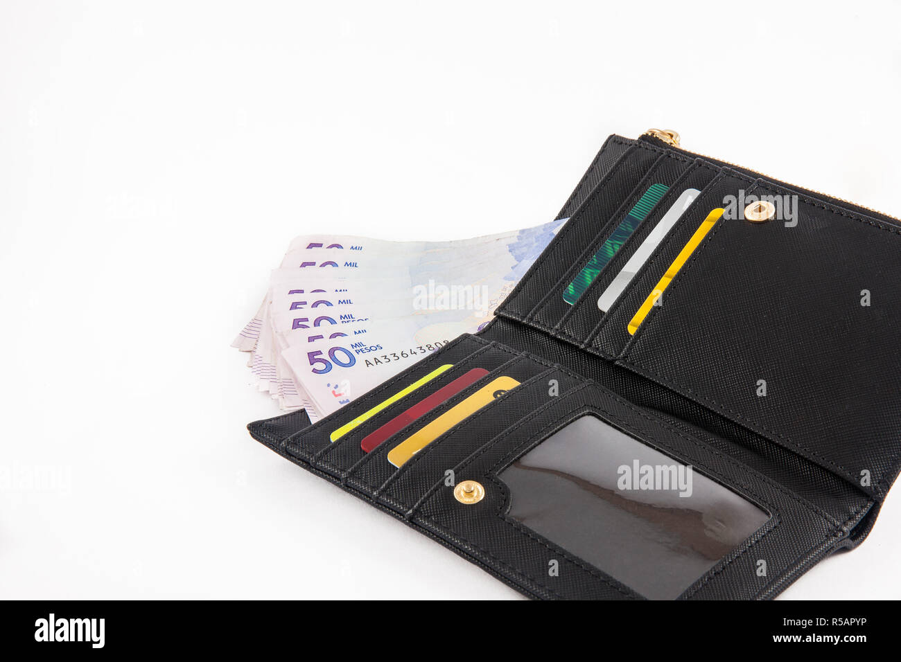 Black wallet filled with money and cards Stock Photo - Alamy
