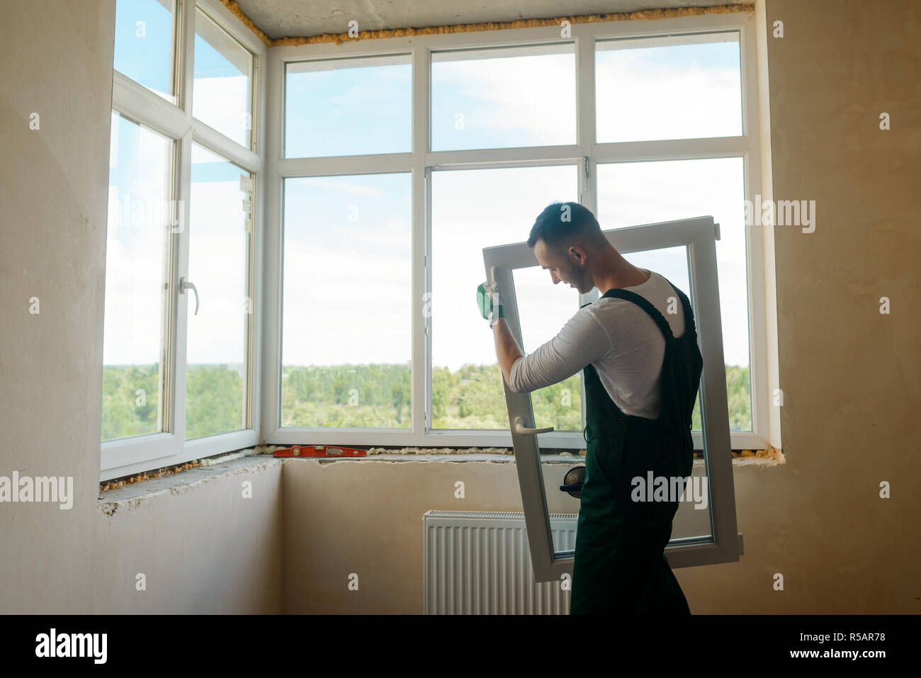 Man is carrying a window Stock Photo - Alamy