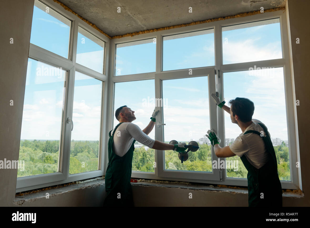 Workers are installing a window Stock Photo - Alamy