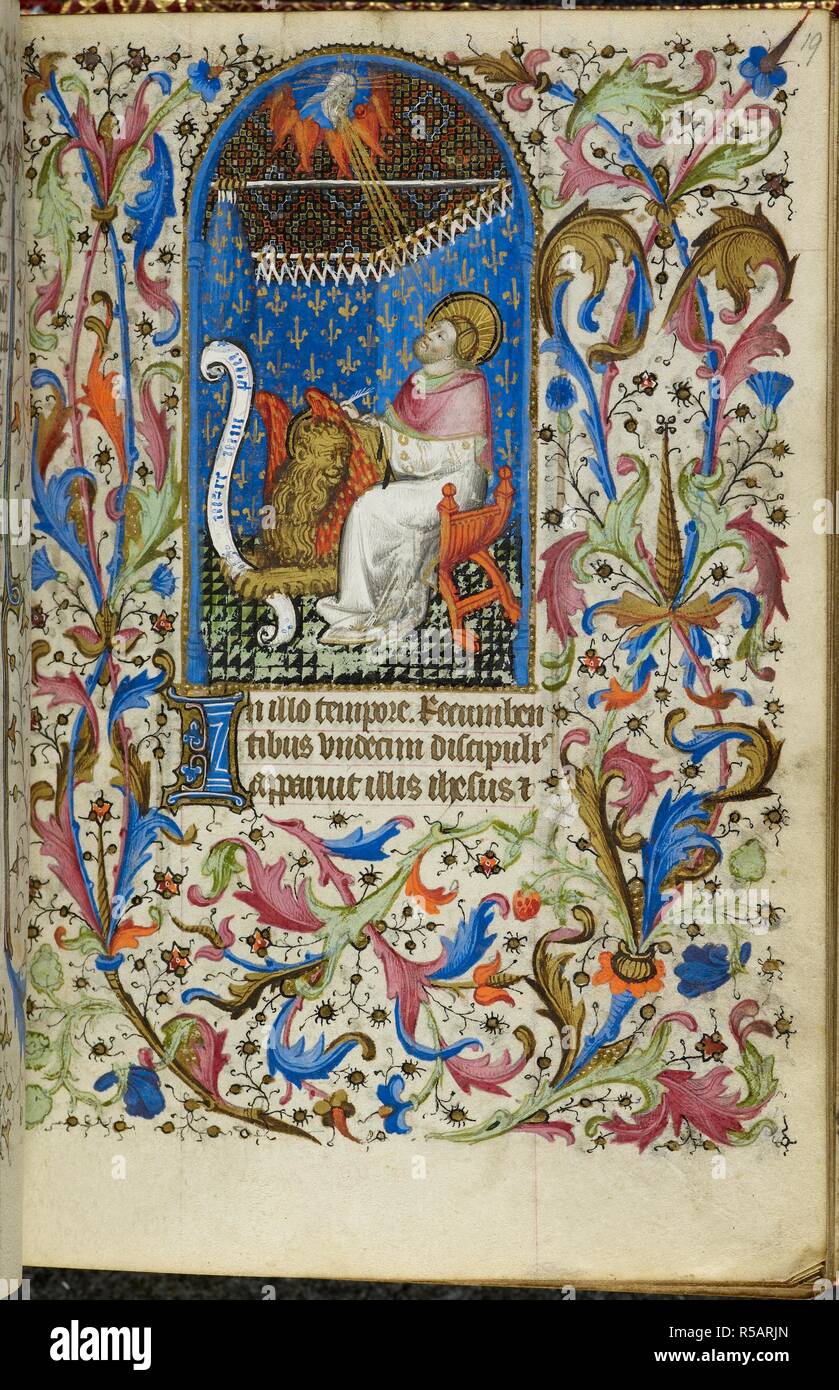 Mark writing, with his evangelist symbol, a winged lion, in front of ...