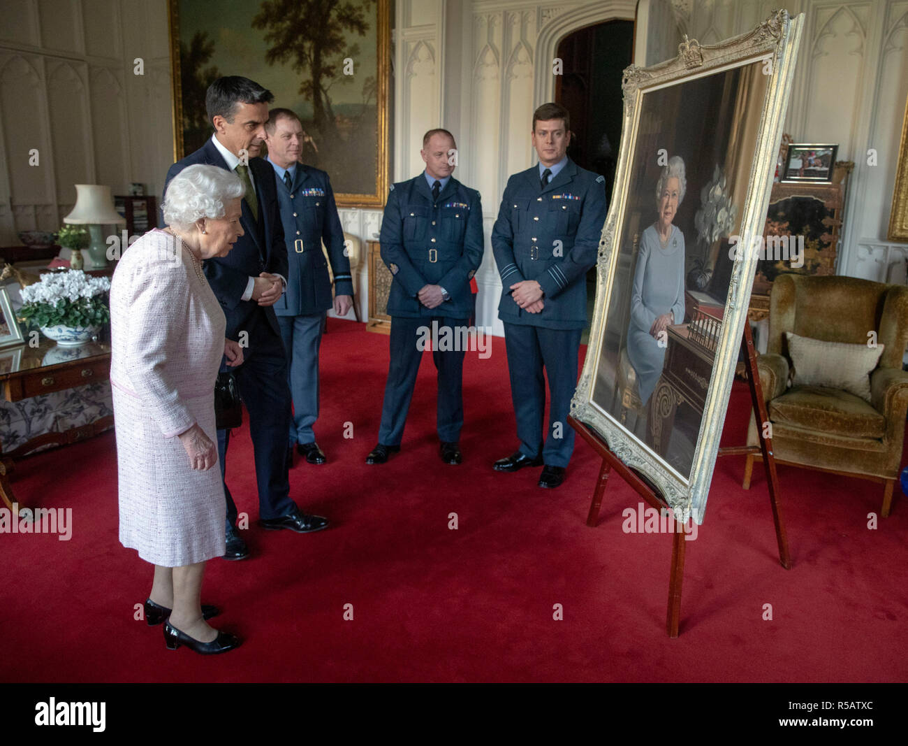Queen Elizabeth II, accompanied by (left to right) artist Stuart Brown ...