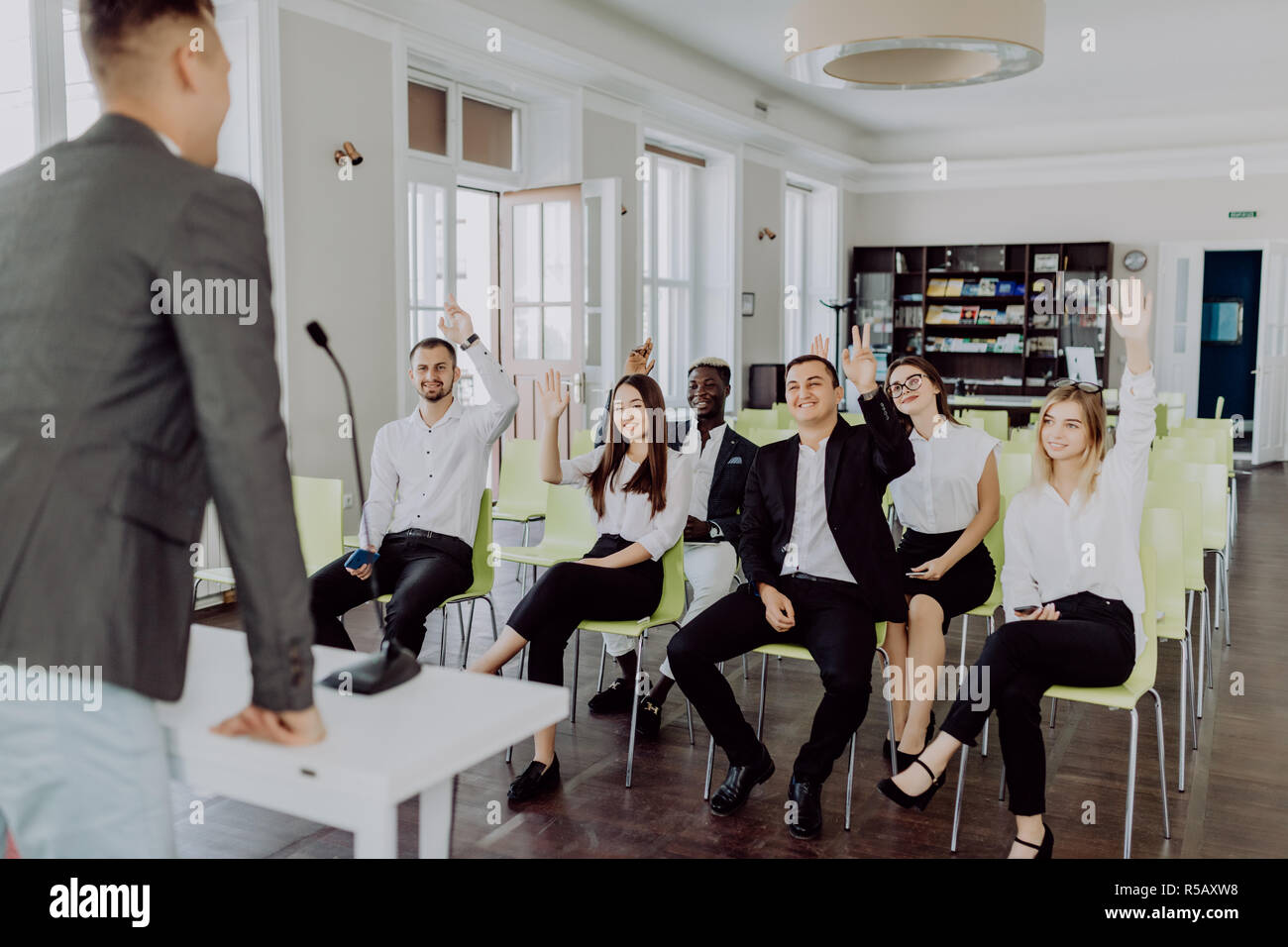 Business coach. Rear view of man gesturing with hand while standing ...