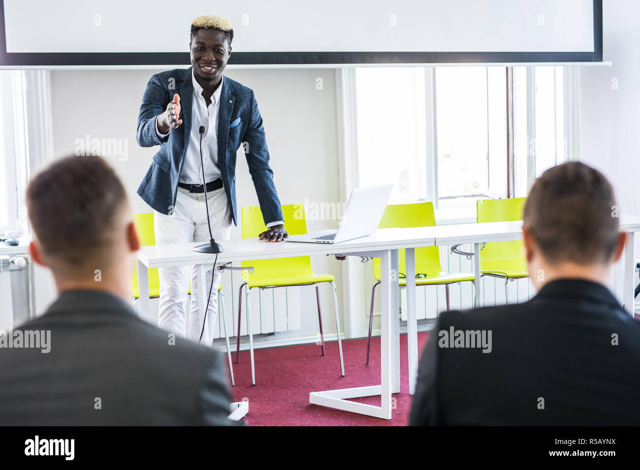 Young man raising hand to ask question, boss leader businessman ...