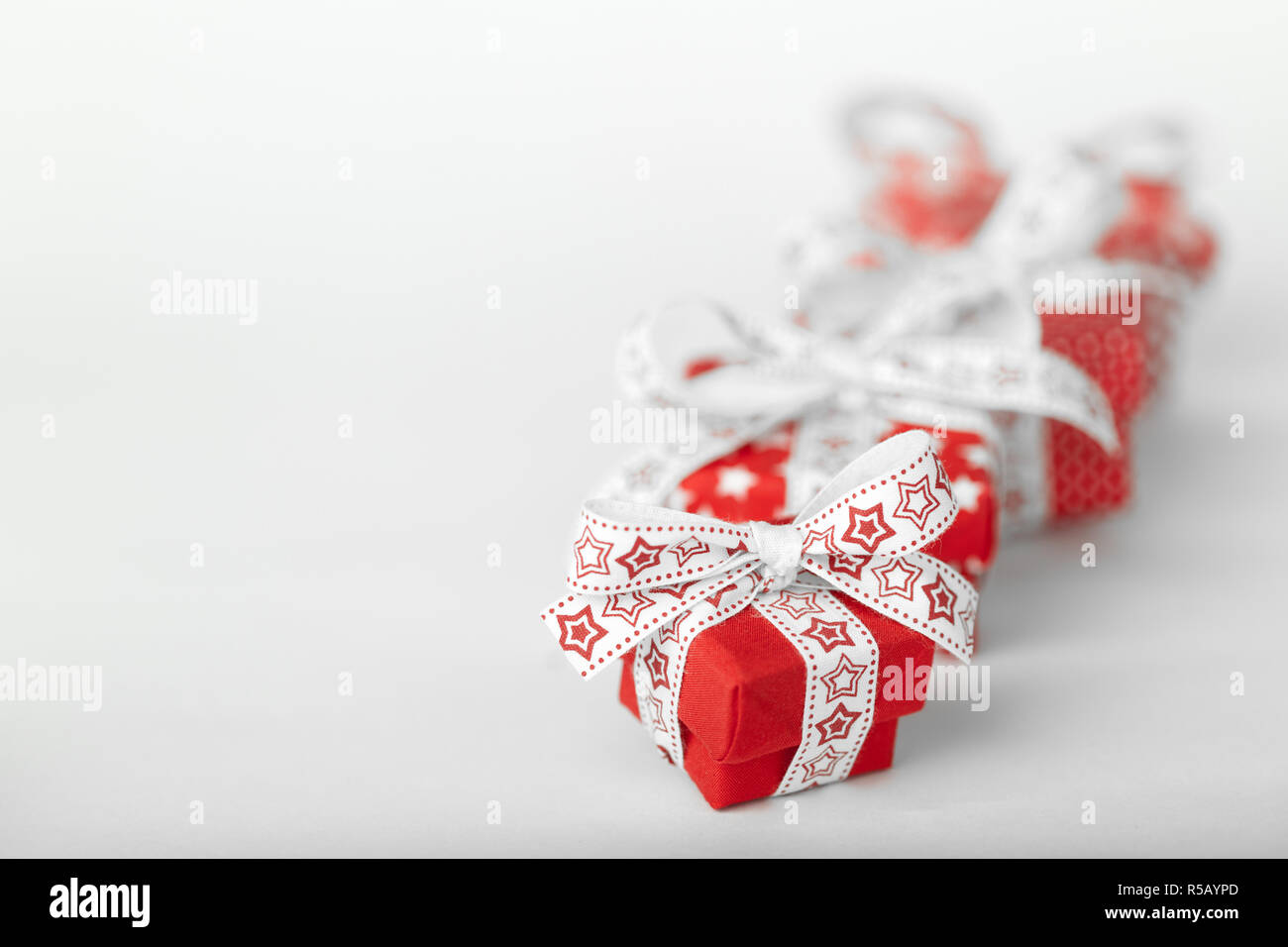 Red Christmas gift boxes on white background Stock Photo - Alamy