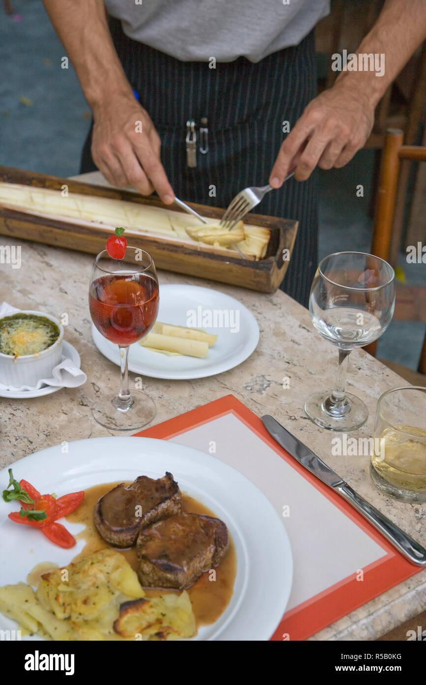 A waiter serving Brazilian food at the popular Aprazivel Restaurant ...