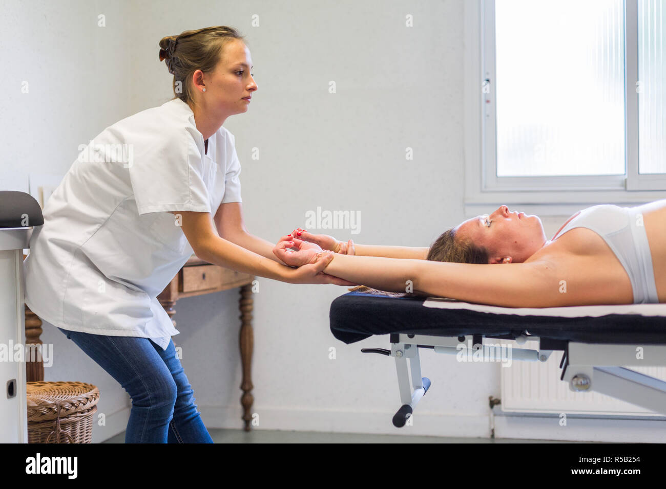 Structural osteopathy session in a pregnant woman Stock Photo - Alamy