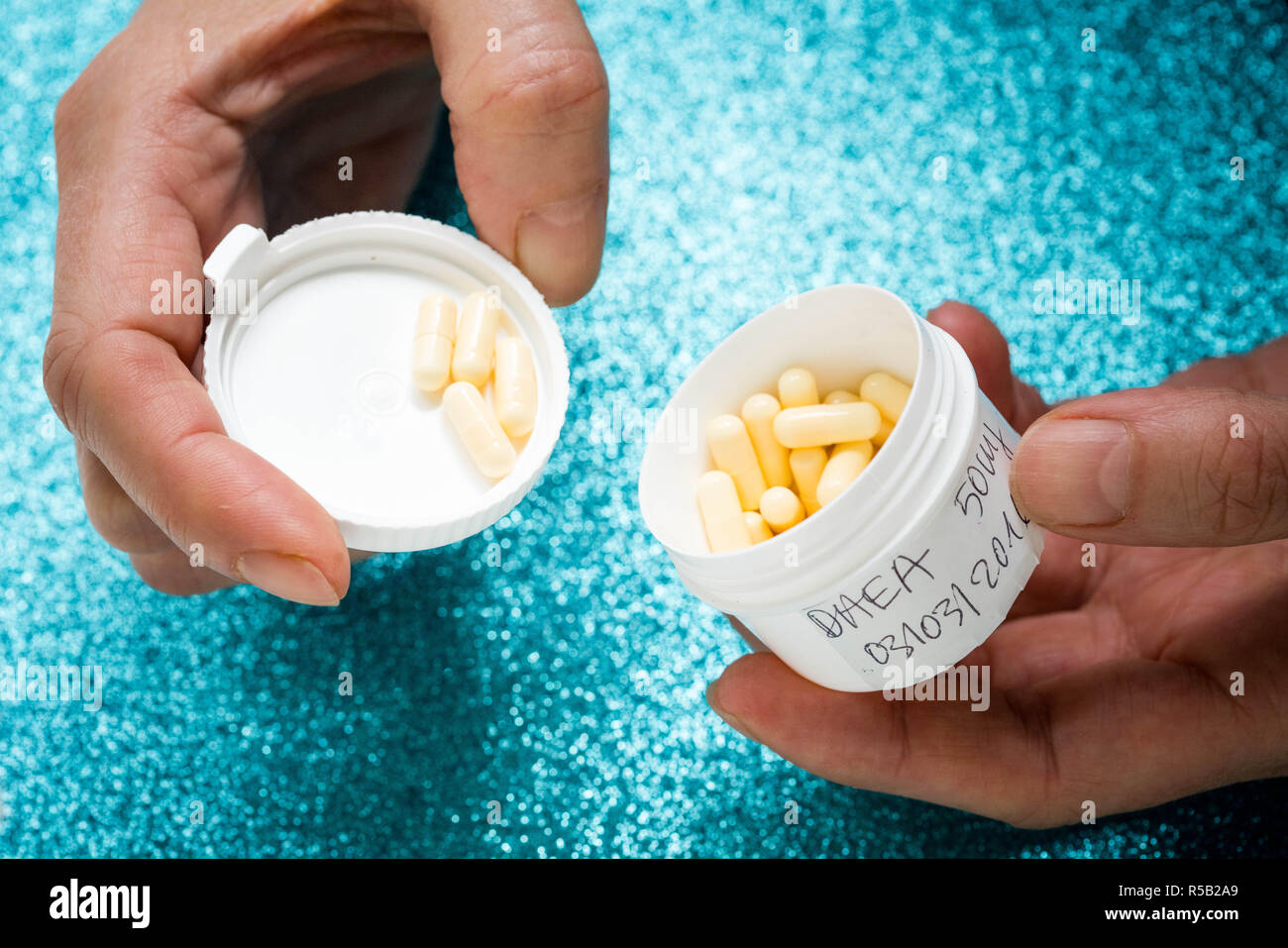 Woman taking DHEA capsules Stock Photo - Alamy