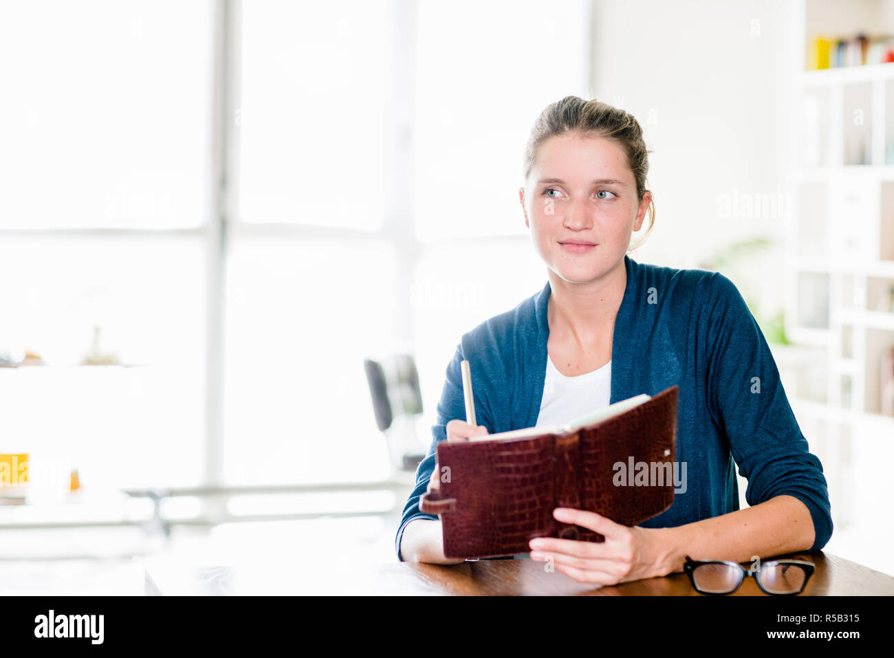 Thoughtful woman pencil notebook hi-res stock photography and images ...