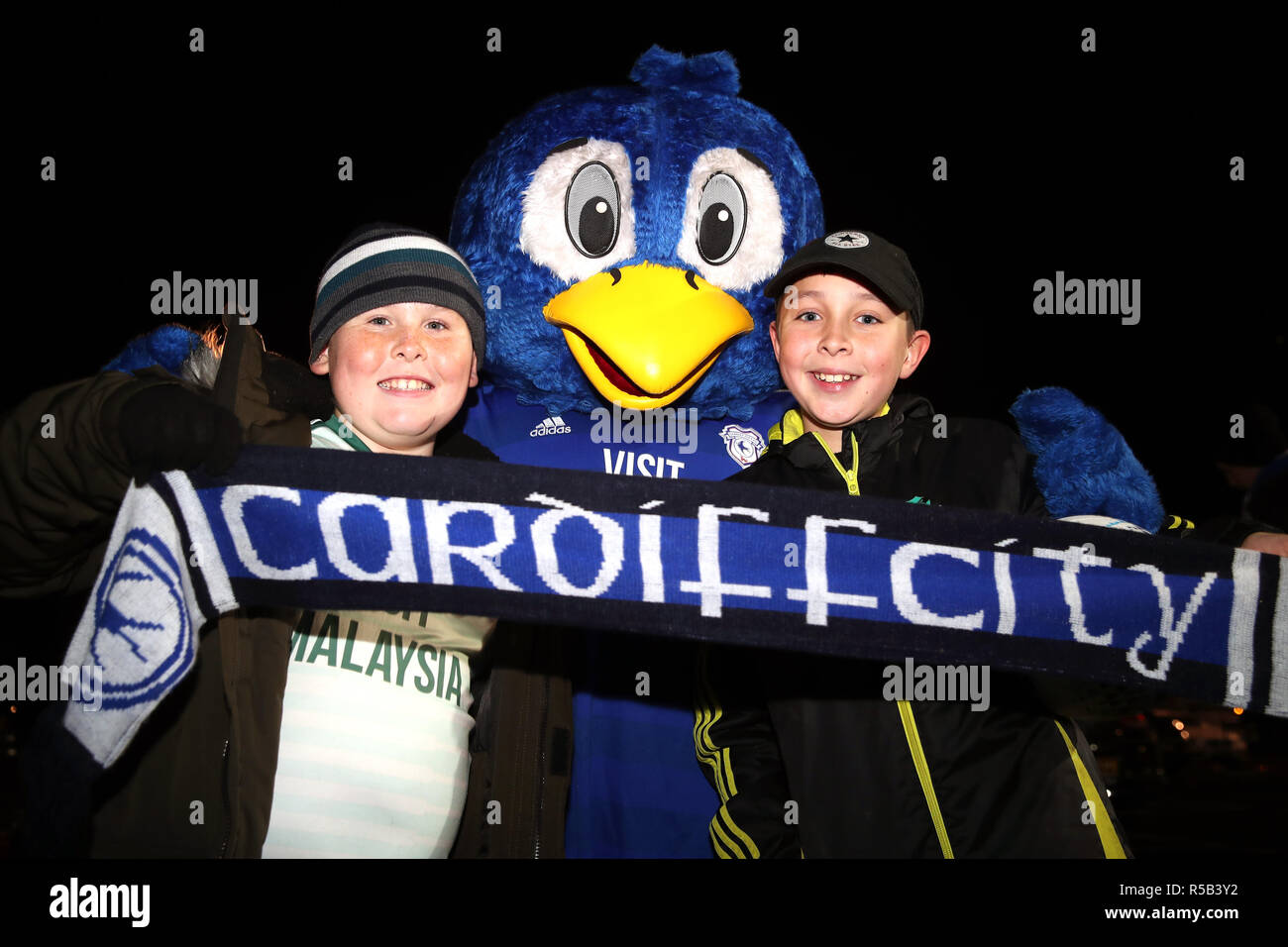 Cardiff City fans pose for a picture with club mascot Bartley Blue ...