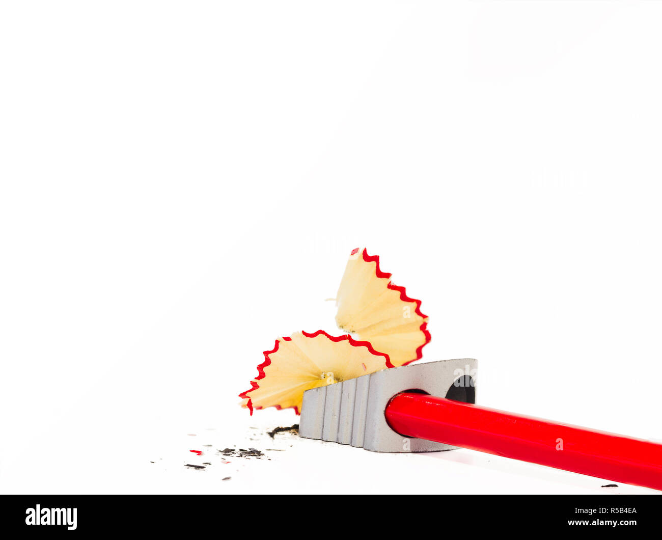 Close up view of a red pencil being sharpened in a metallic pencil ...