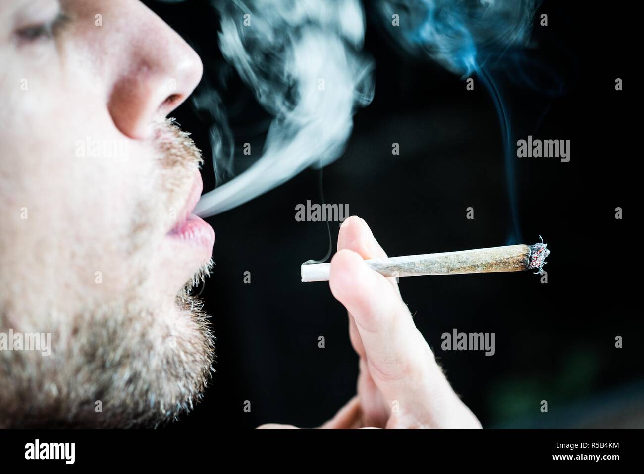 Man smoking a joint Stock Photo - Alamy