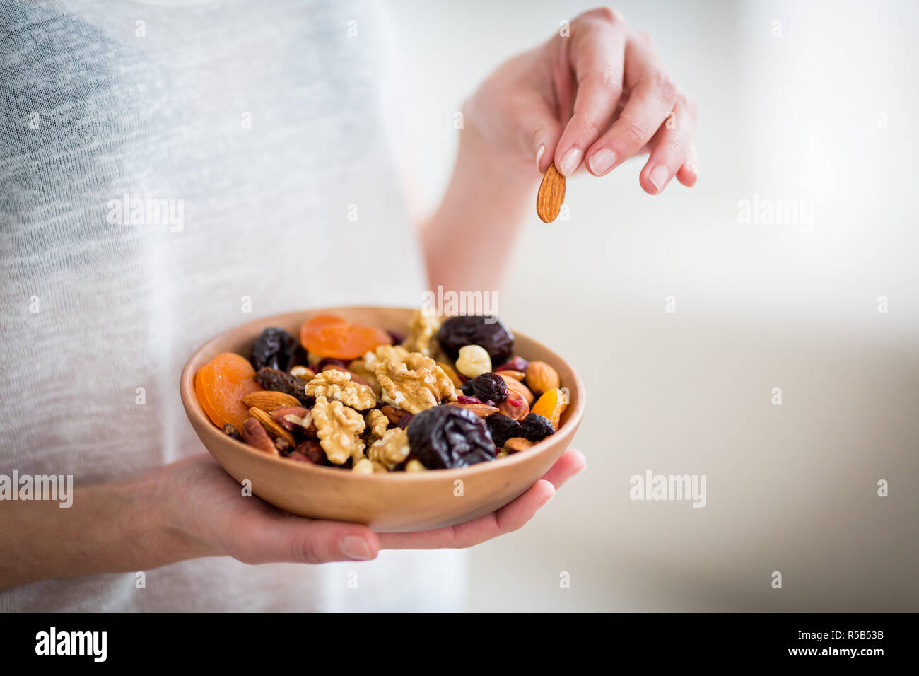 Woman eating almond nuts hi-res stock photography and images - Alamy
