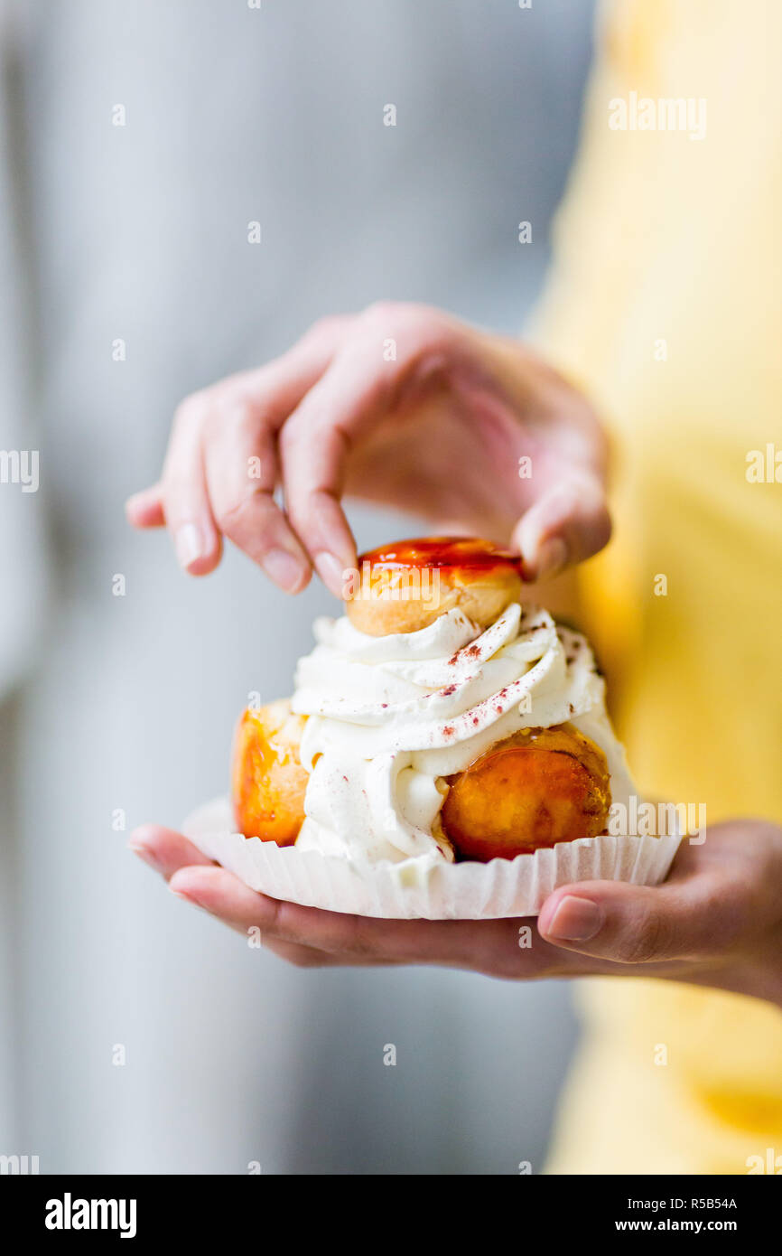 Woman eating pastry Stock Photo - Alamy