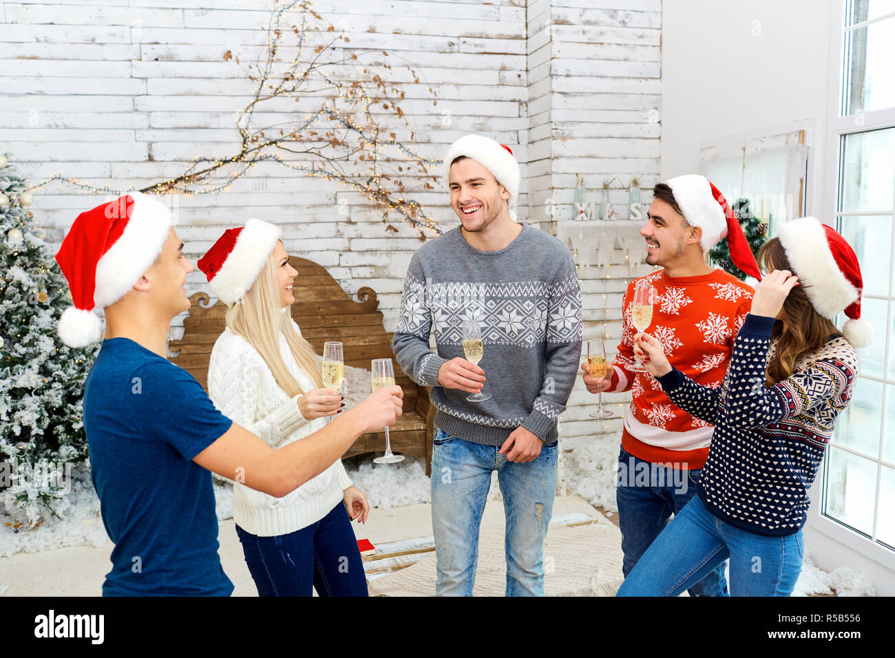 A group of friends with gifts at a Christmas party Stock Photo - Alamy