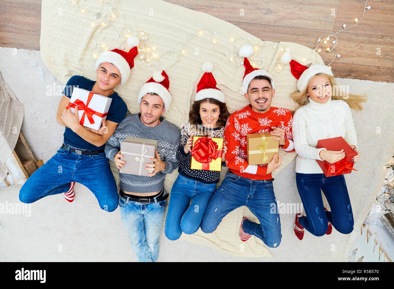 A group of friends with gifts at a Christmas party Stock Photo - Alamy