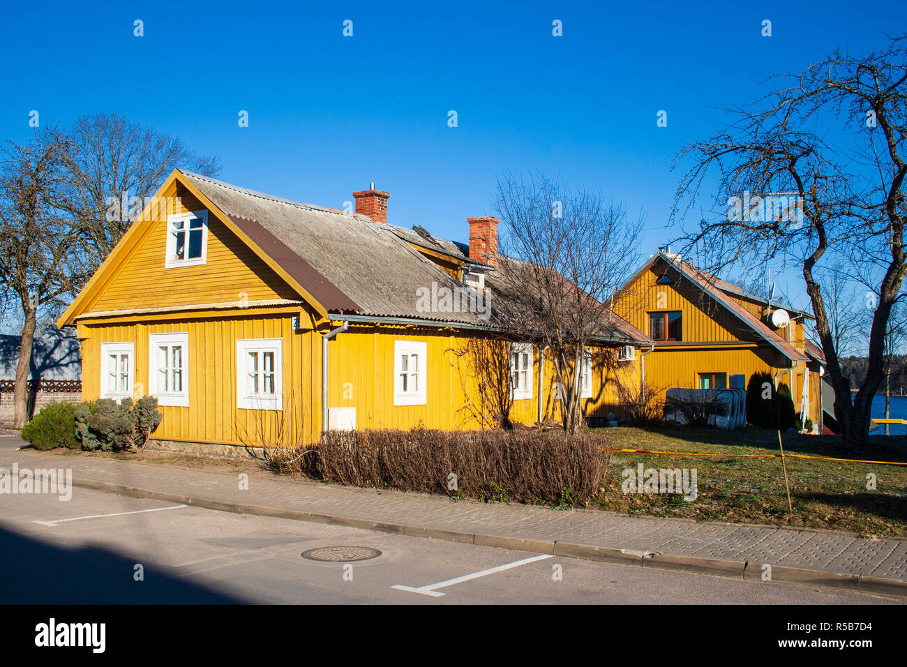 Old Lithuanian traditional wooden yellow house with three windows Stock ...