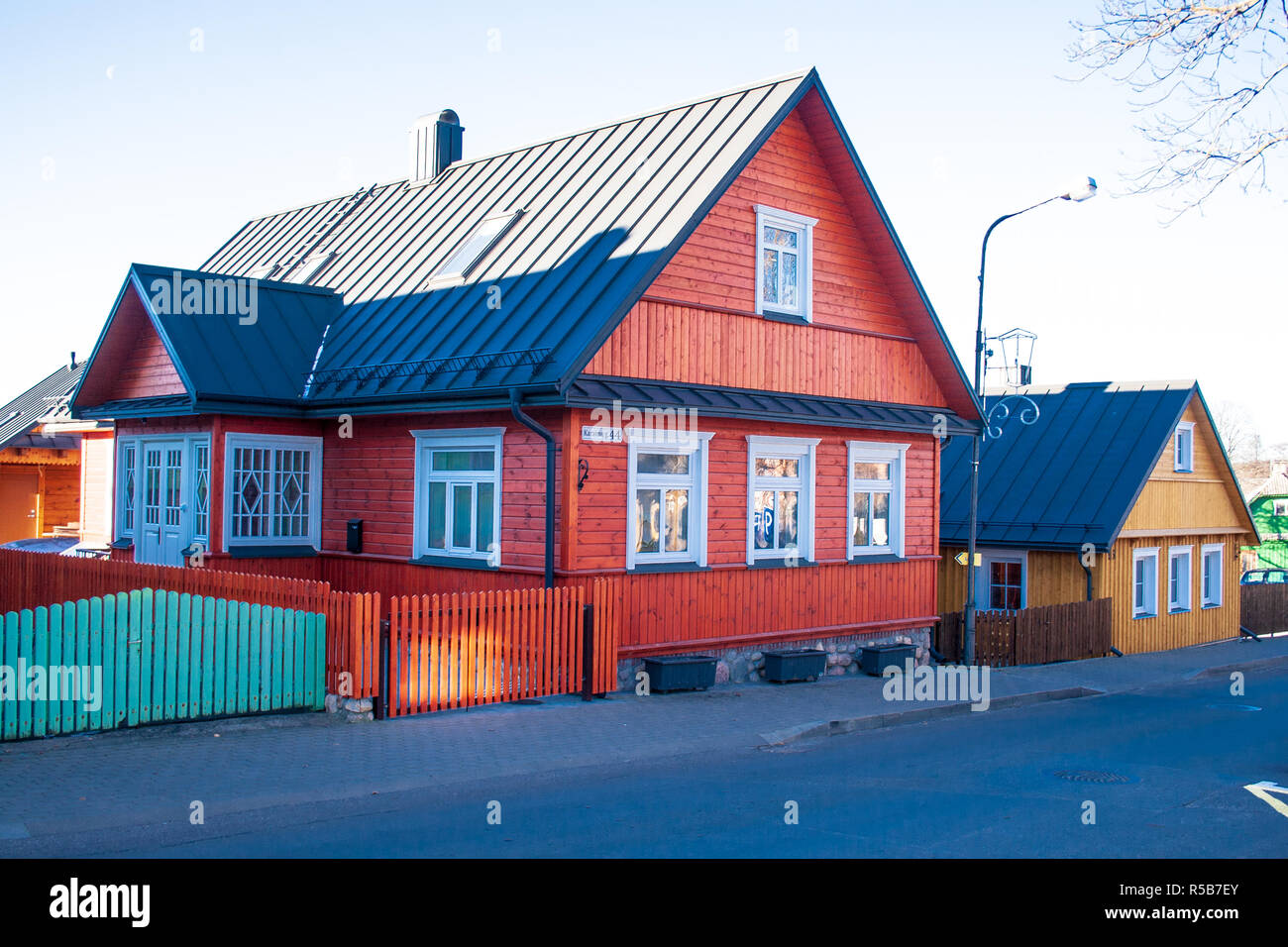 Old beautiful Lithuanian traditional wooden red an yellow house with ...