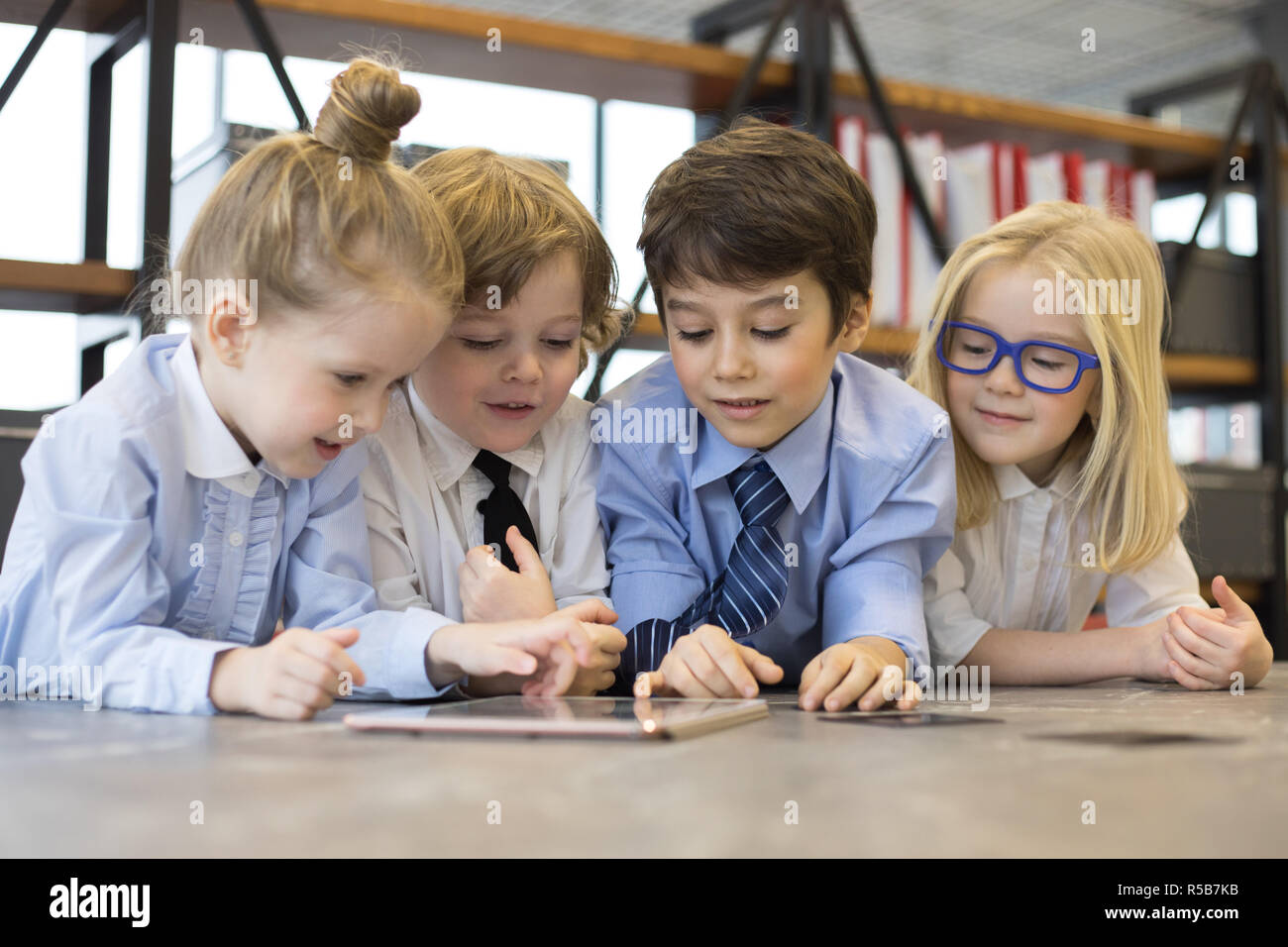 Little children businessmen sharing ideas in office Stock Photo - Alamy