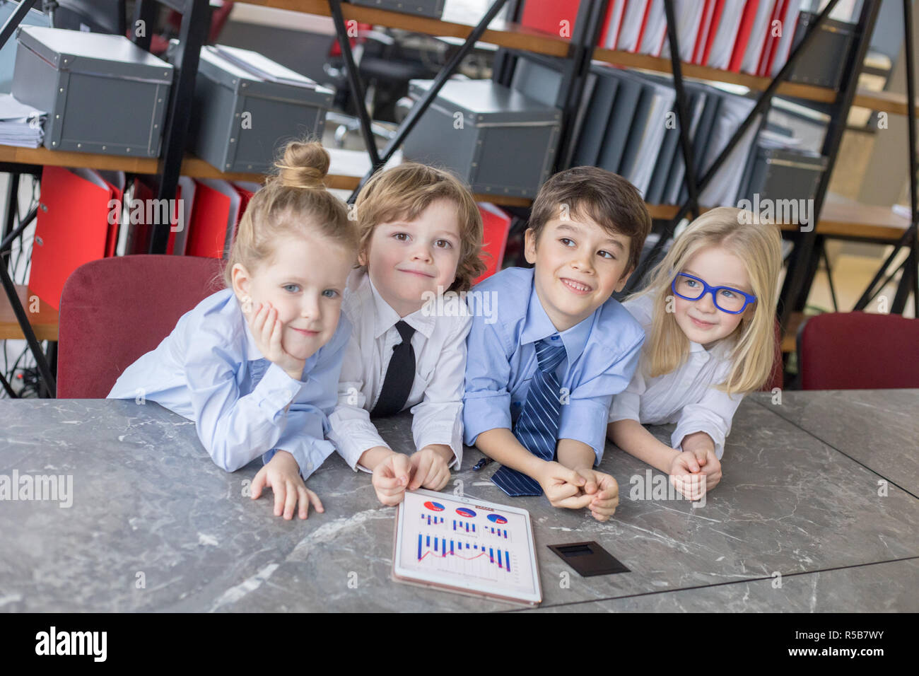 Little children businessmen sharing ideas in office Stock Photo - Alamy