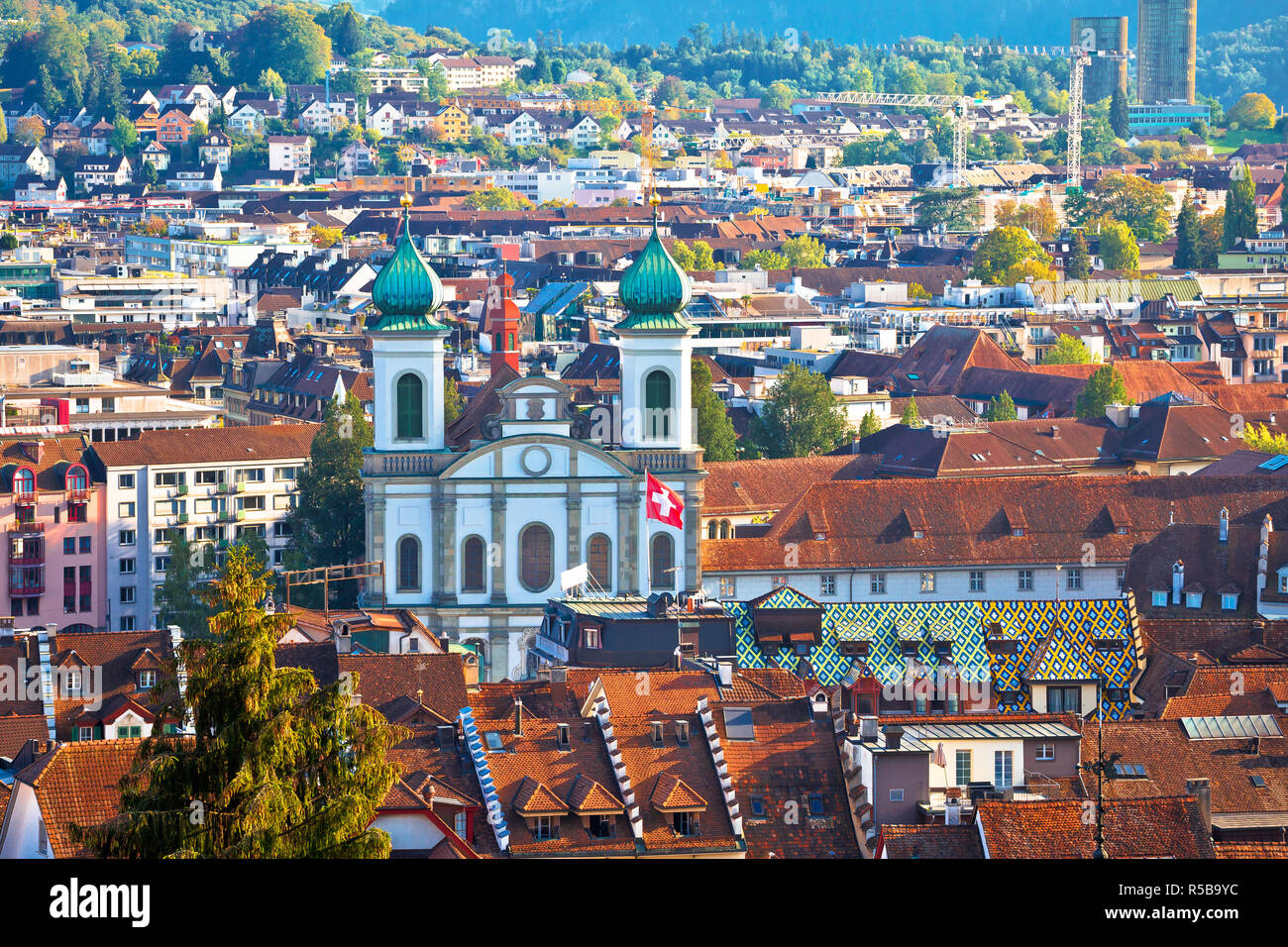 City of Luzern church and rooftops aerial view, Alps and lakes in ...