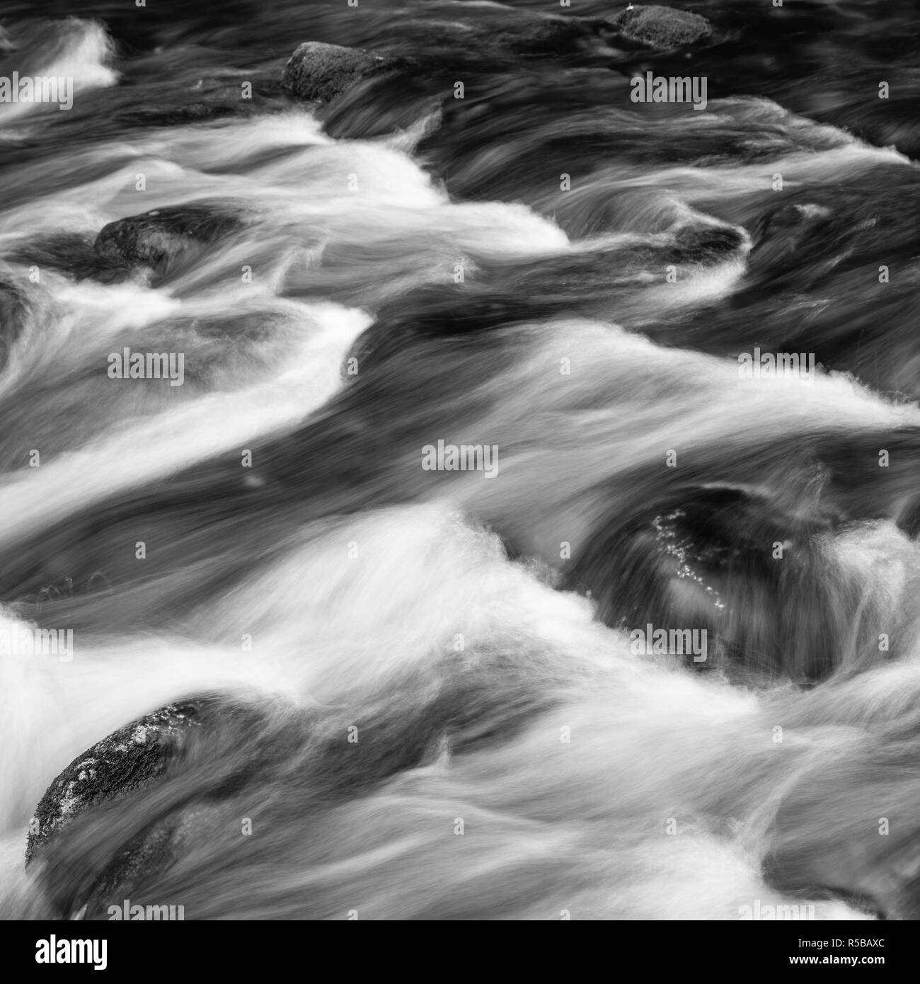 Detail landscape image of river flowing over rocks with long exposure ...