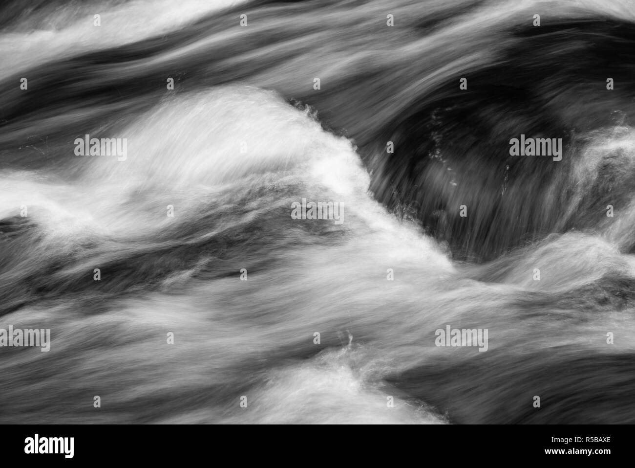 Detail landscape image of river flowing over rocks with long exposure ...
