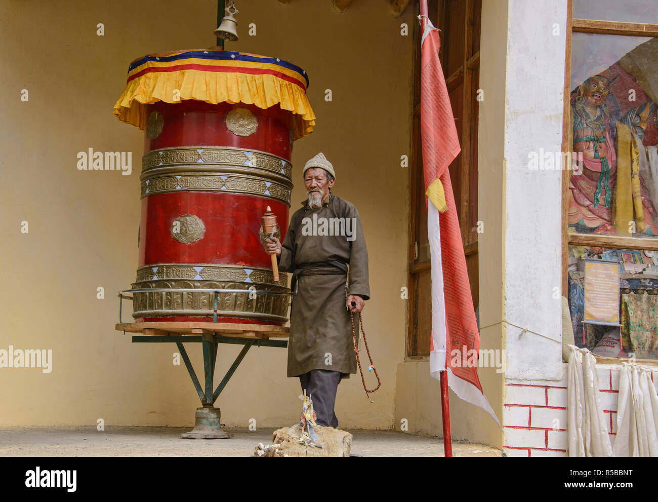Ladakhi pilgrim and prayer wheel, Lamayuru, Ladakh, India Stock Photo ...