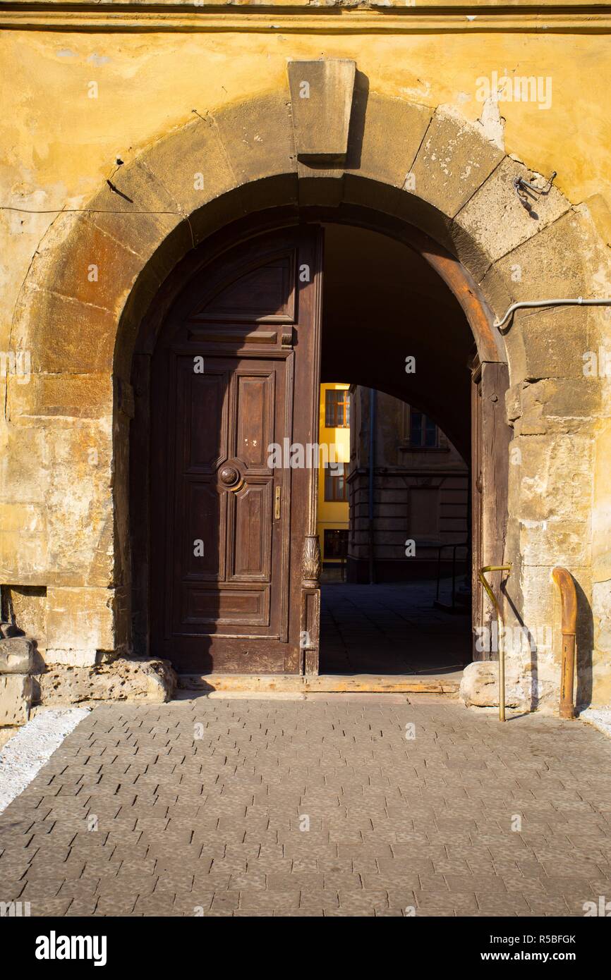 old wooden gates of the old yellow building Stock Photo - Alamy