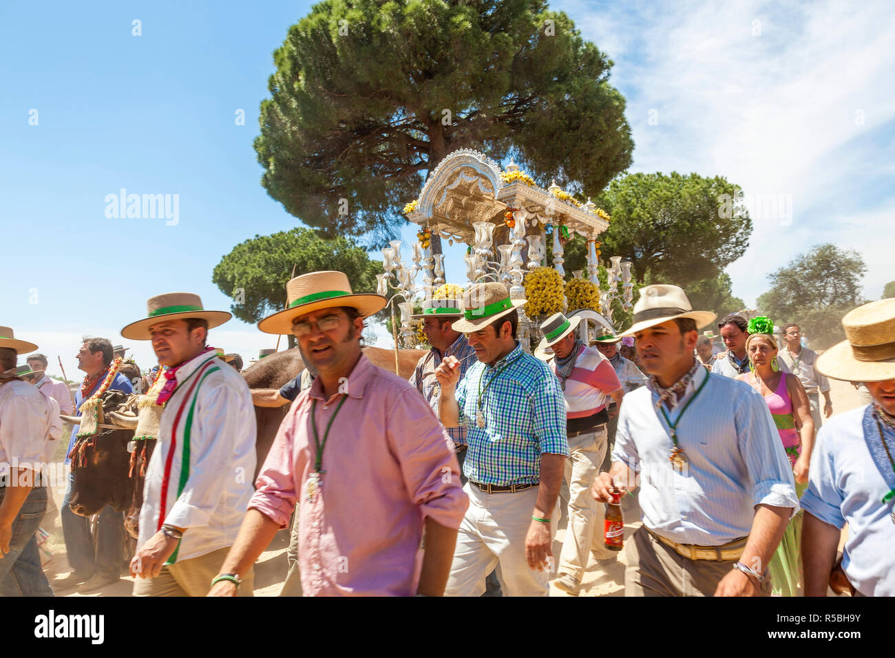Pilgrims walk beside Simpecado or float containing symbol of The Virgin ...