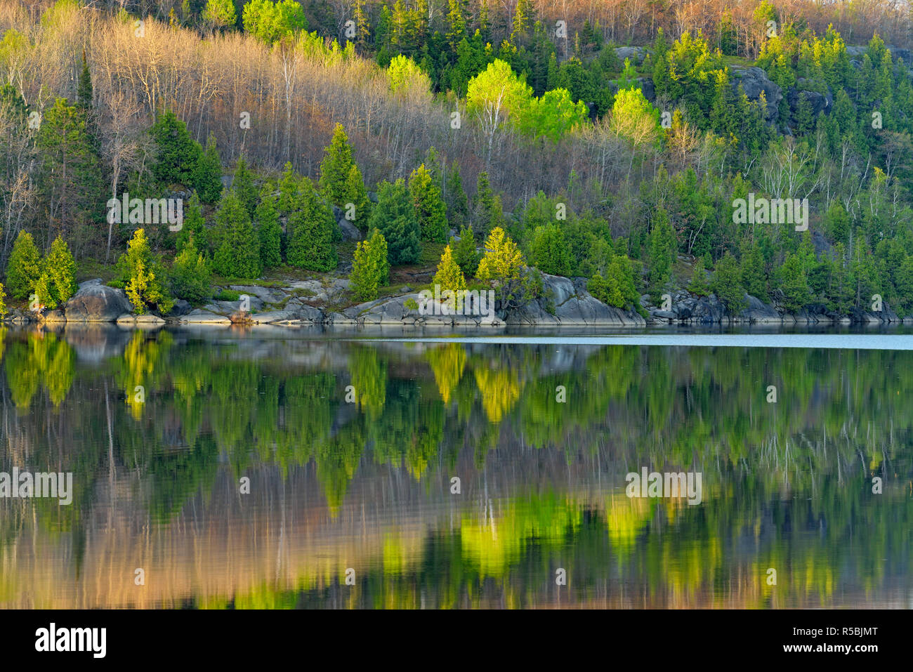 Spring reflections in Simon Lake, Greater Sudbury, Ontario, Canada ...