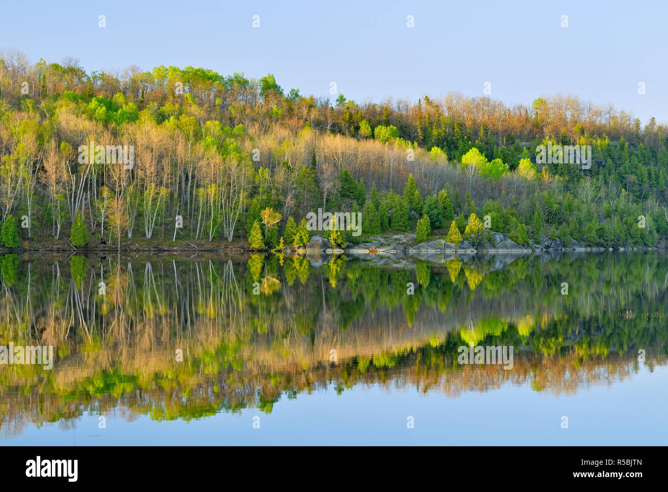 Spring reflections in Simon Lake, Greater Sudbury, Ontario, Canada ...