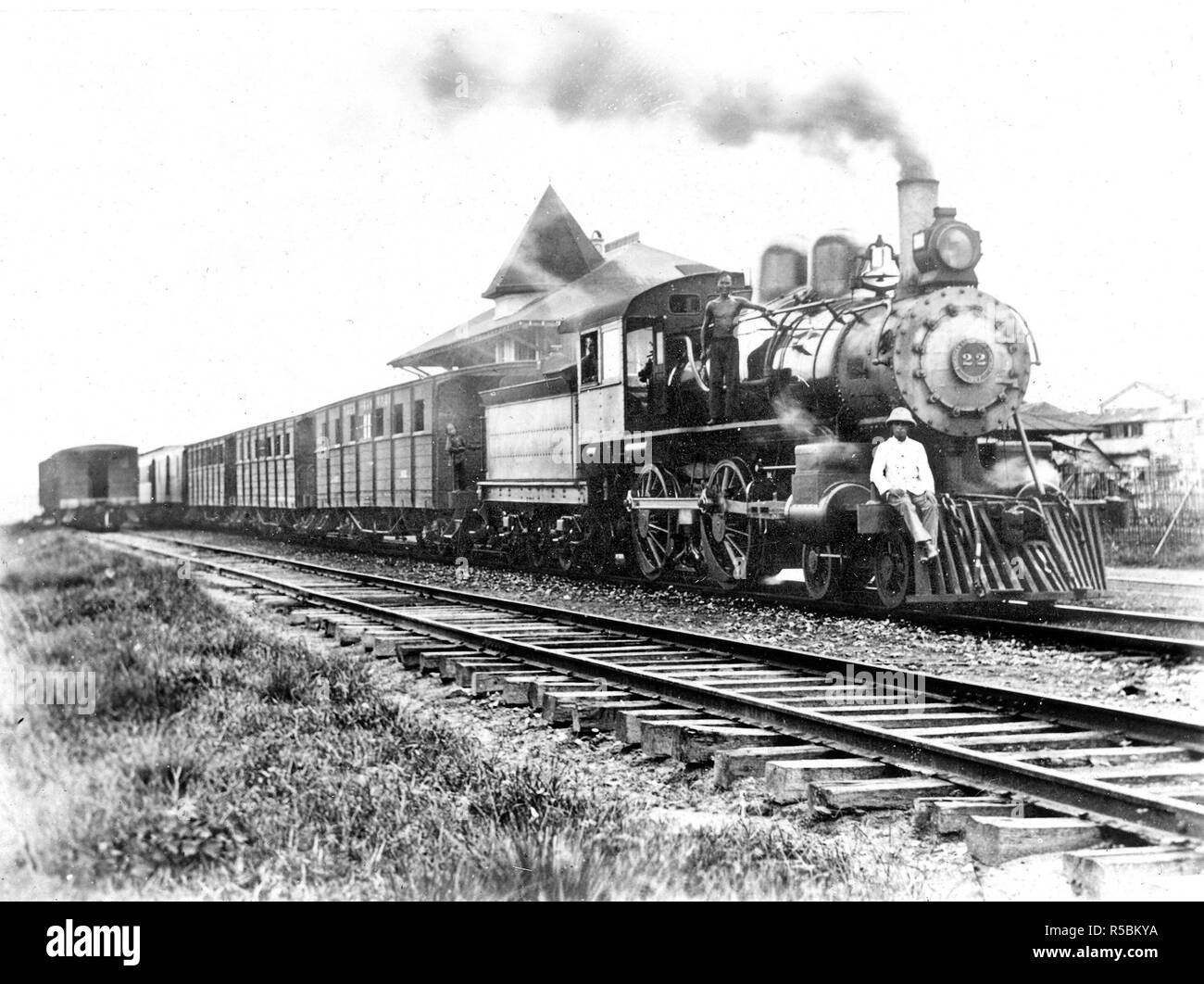 Steam locomotive 22 with a Chinese train crew pulling out of a station ...