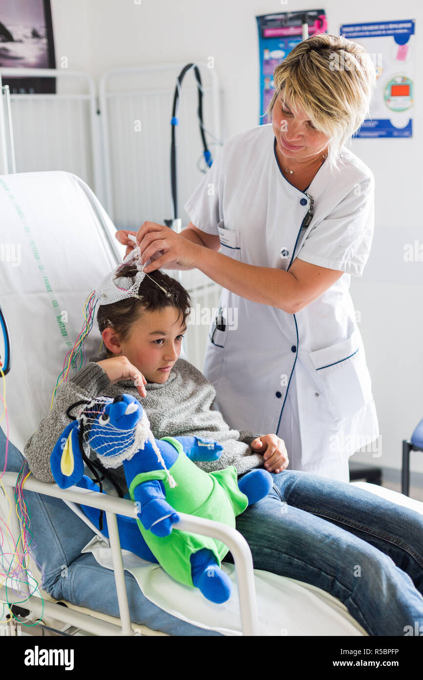 Child undergoing an electroencephalogram (EEG), epilepsy screening ...