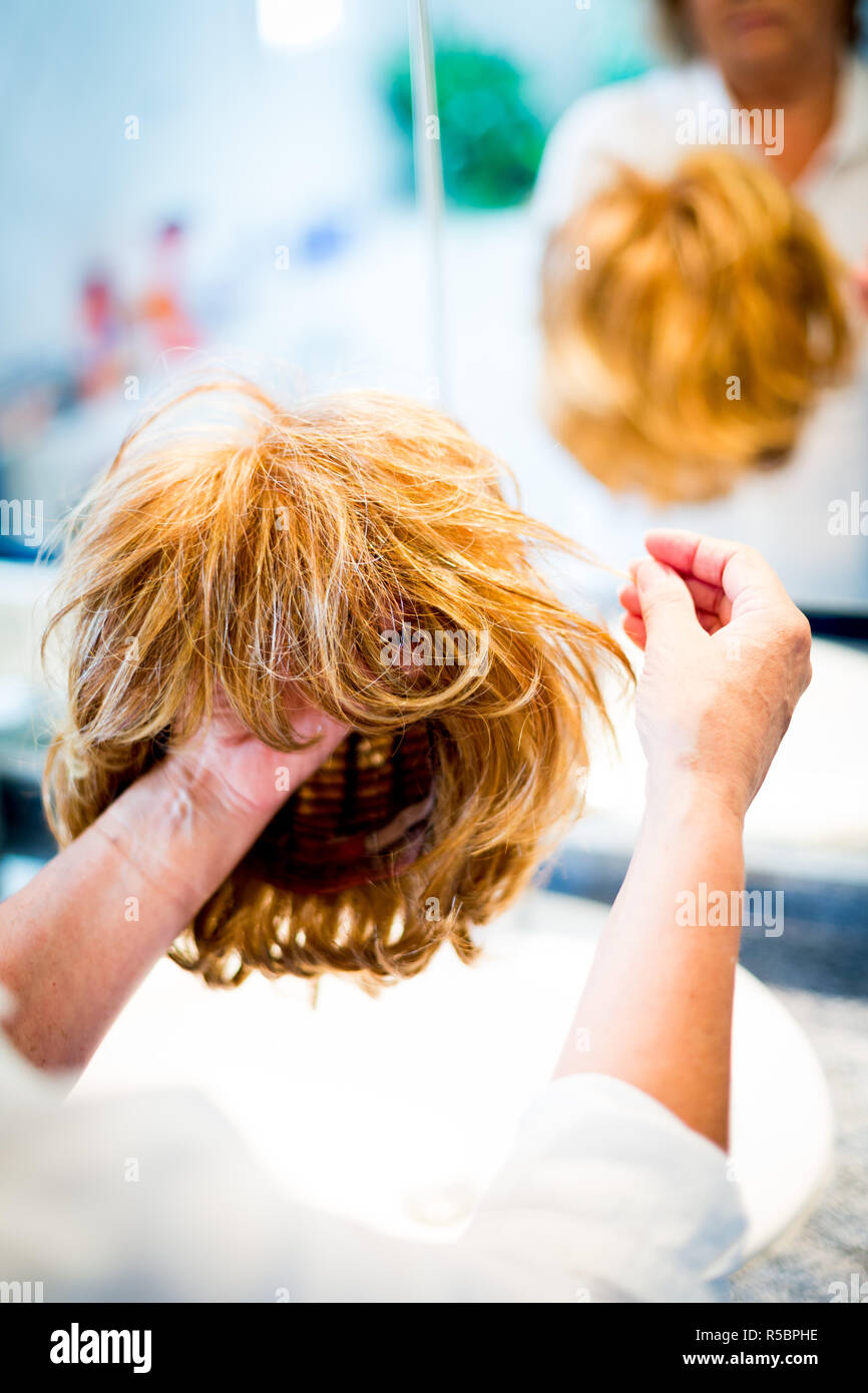Woman holding wig Stock Photo - Alamy