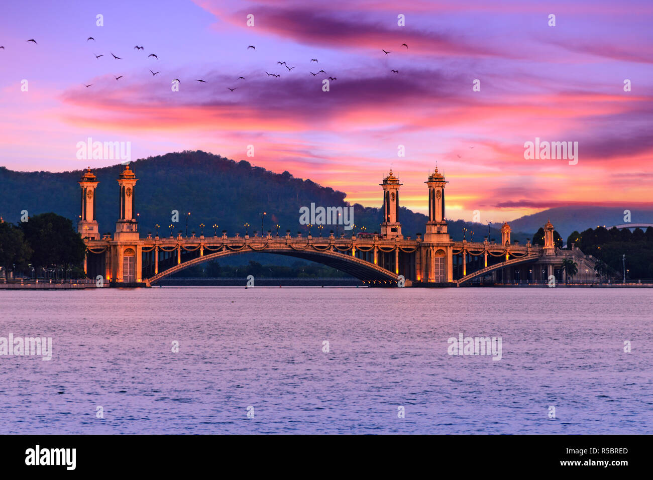 Illuminated bridge over the river, twilight, evening view on Putra lake ...