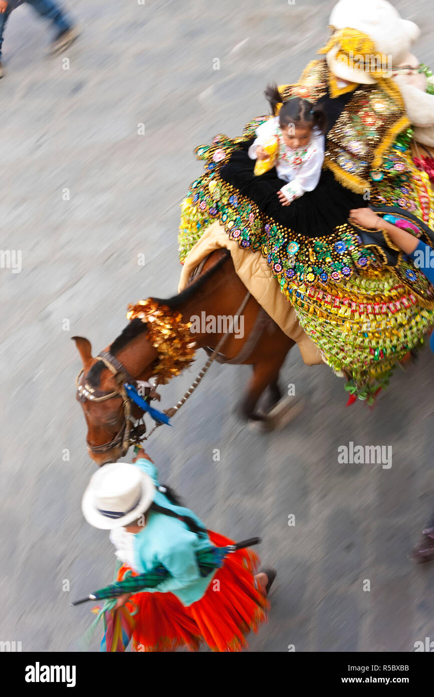 Children on horse in christian parade, led by indigenous woman, Cueneca ...