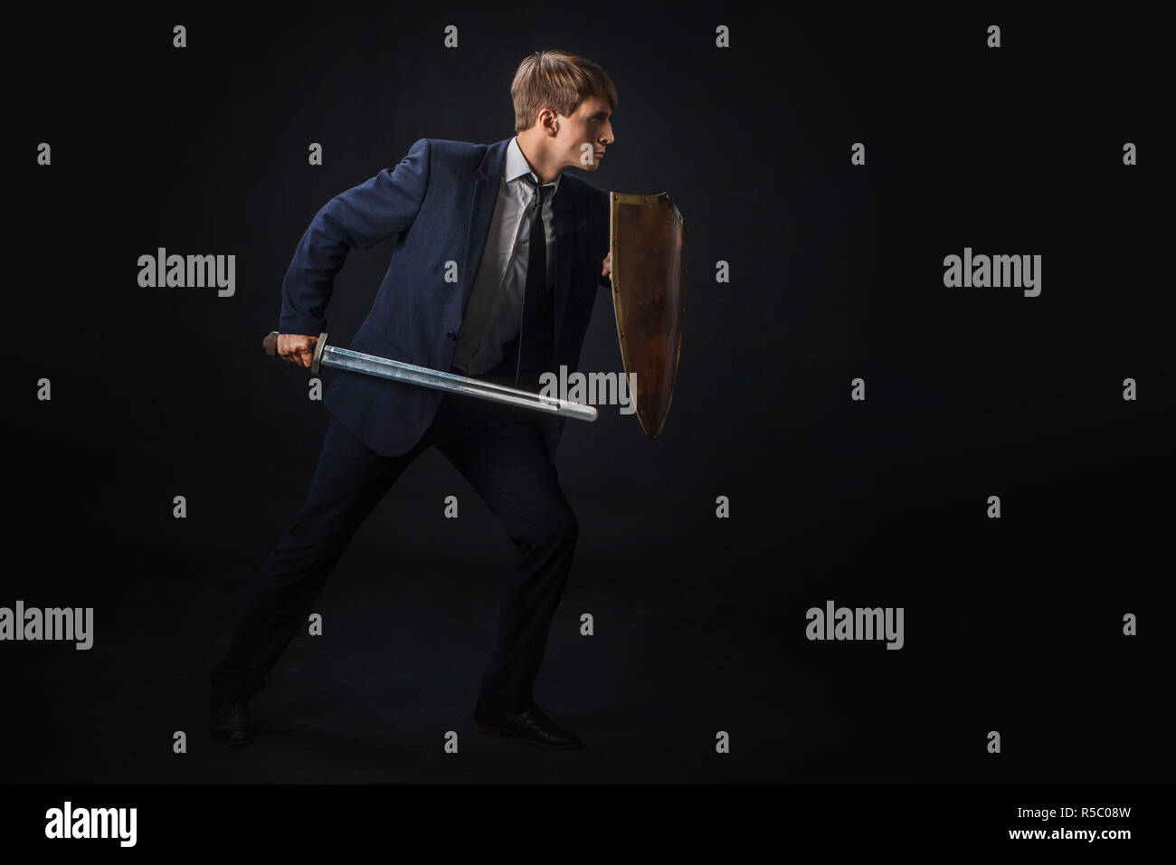Man in suit sword shield money hi-res stock photography and images - Alamy