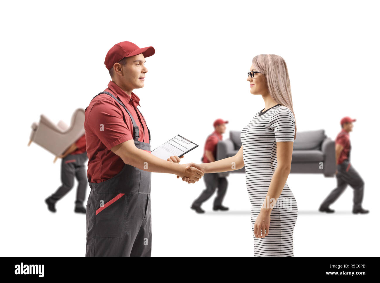 Mover shaking hands with a woman and movers carrying furniture in the ...