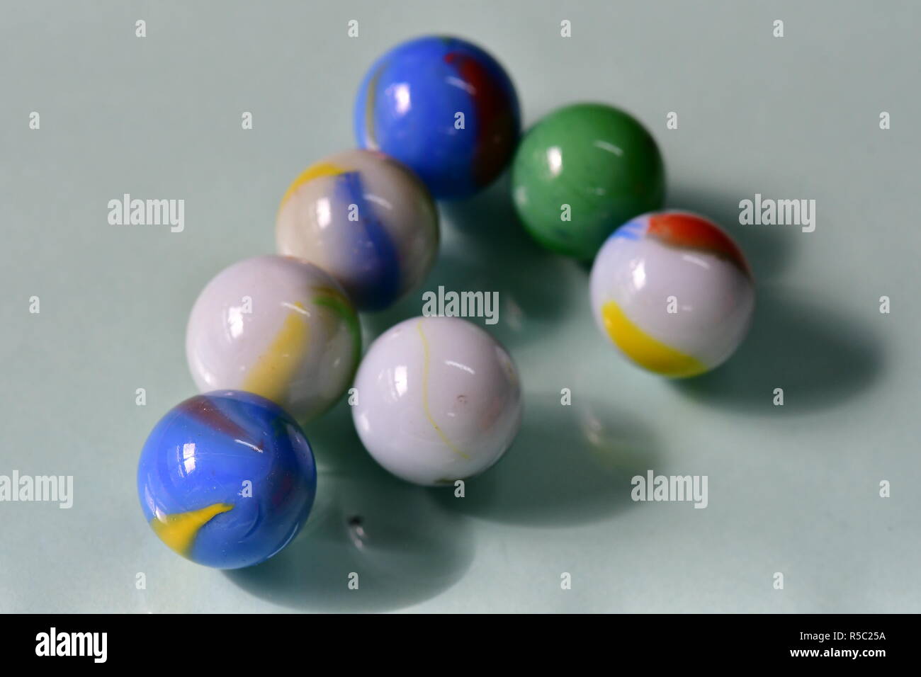 Marbles at close up photo with reflections and shadows Stock Photo - Alamy