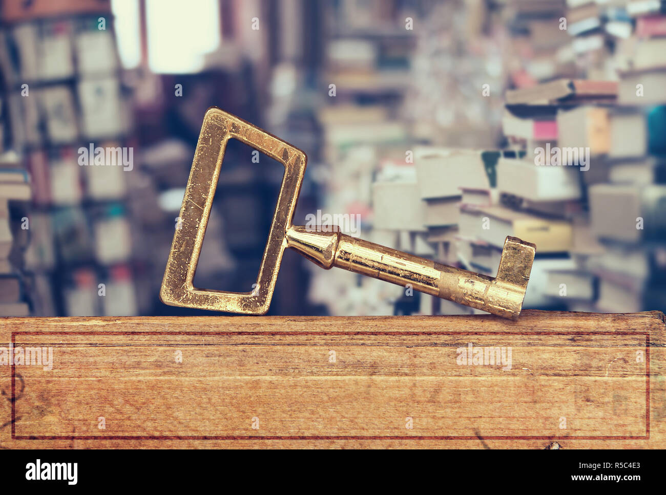 Reading is the key. Symbolic key standing on a wooden desk in the ...