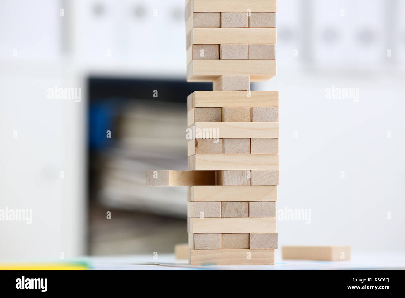 Businessman plays in a strategy of jenga hand Stock Photo - Alamy
