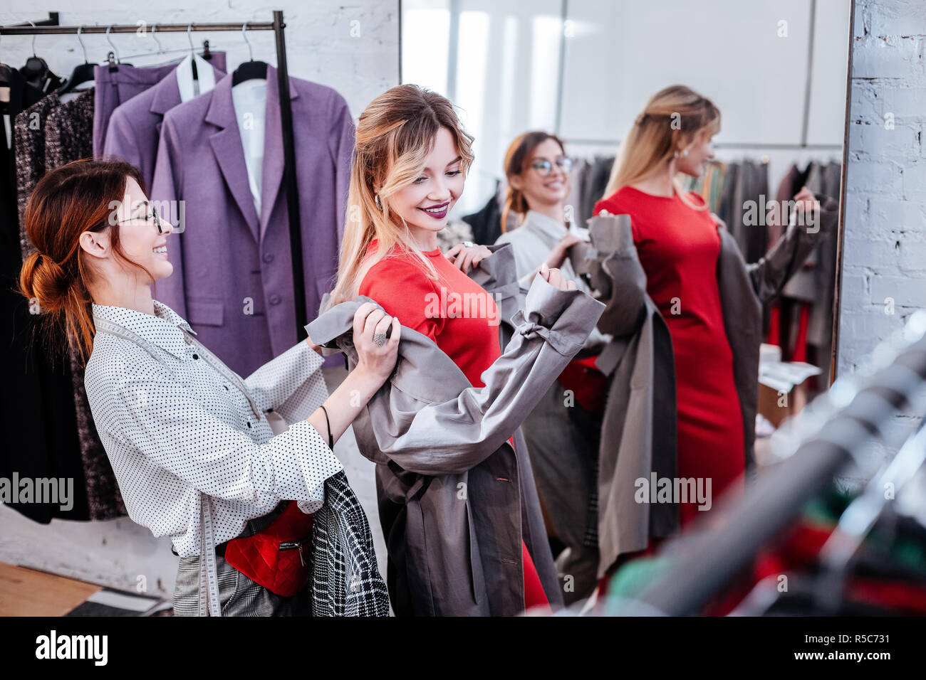 Clothes on model. Famous talented fashion designer putting clothes from ...