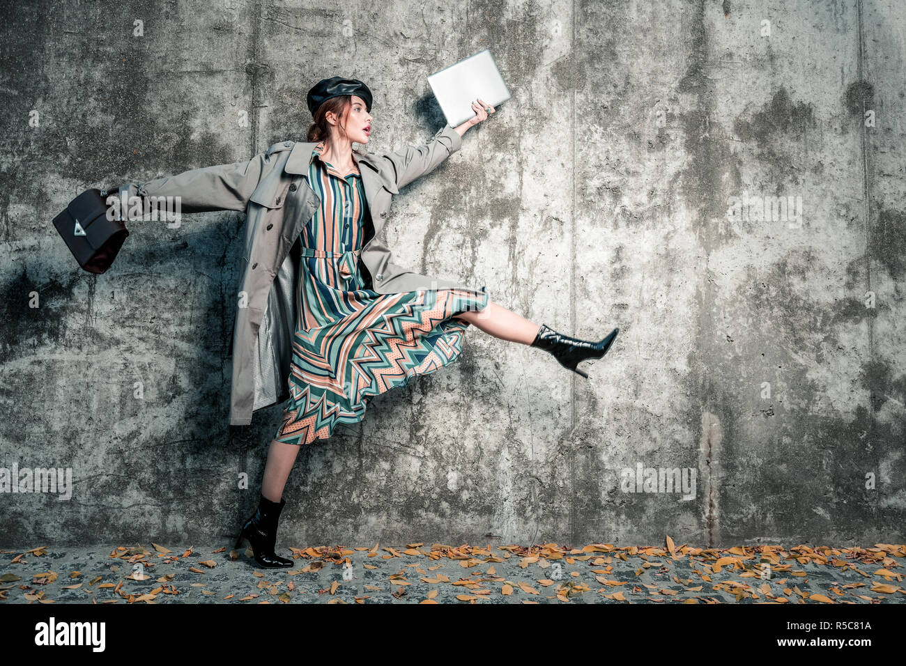 High-heeled boots. Red-haired photo model posing in black high-heeled ...