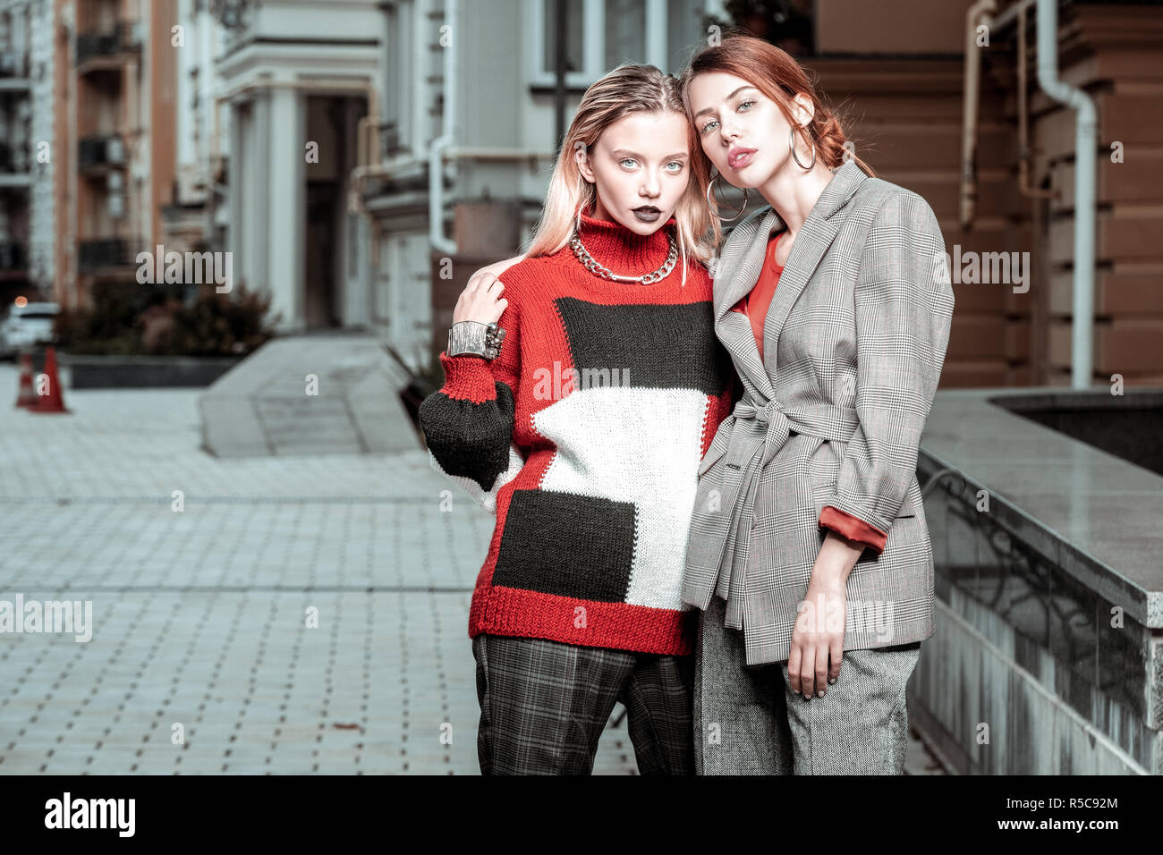 Glamorous models. Two trendy glamorous fashion models hugging while ...